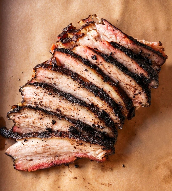 This isn't just brisket, it's a masterclass in patience and smoke, sliced thick with that perfect pink ring of glory.