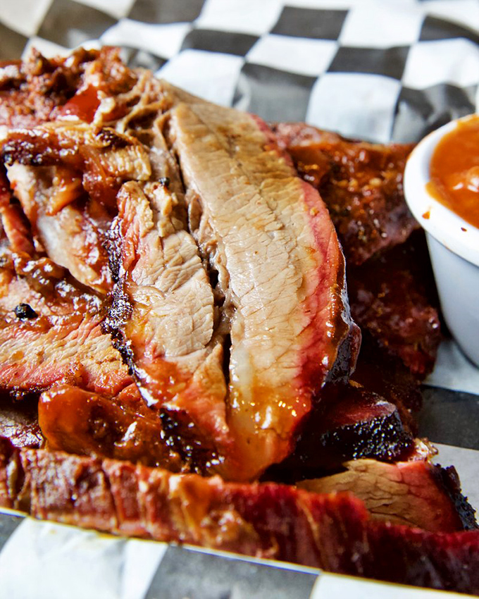 Behold the brisket in all its glory &ndash; that pink smoke ring isn't just for show, it's a barbecue badge of honor earned through hours of patient smoking.