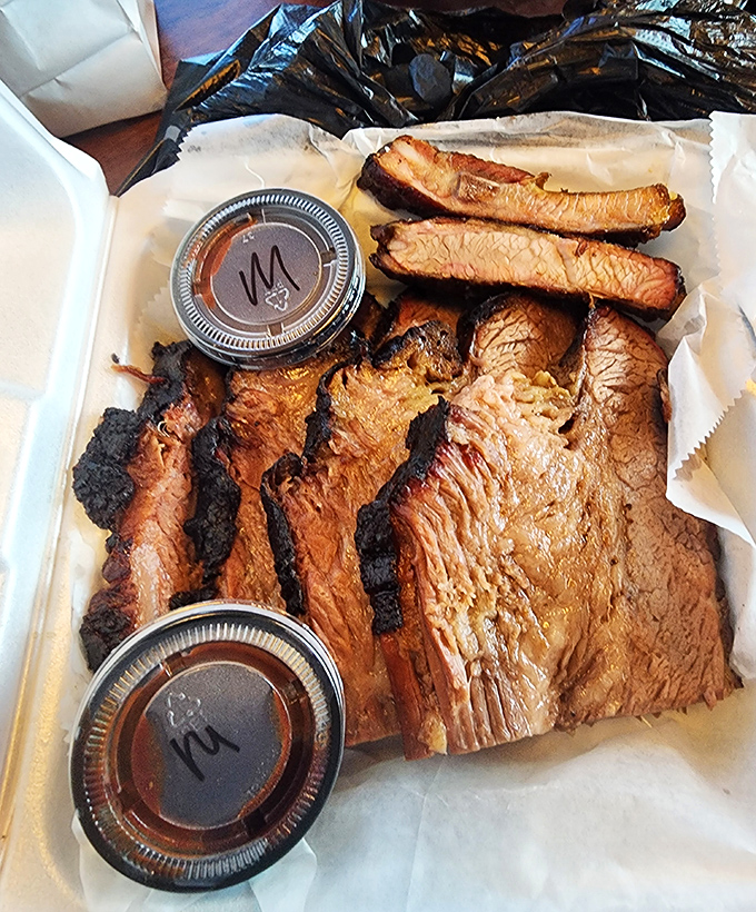 Brisket that doesn't need a filter&mdash;just look at that bark! Two sauce cups stand by, knowing full well this masterpiece could go gloriously naked.