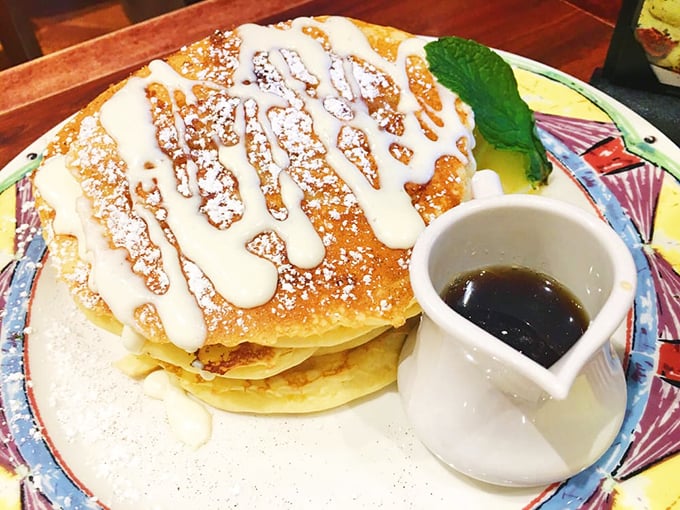 These pancakes aren't just topped with cream – they're having a full-on love affair with it. Maple syrup plays willing accomplice.