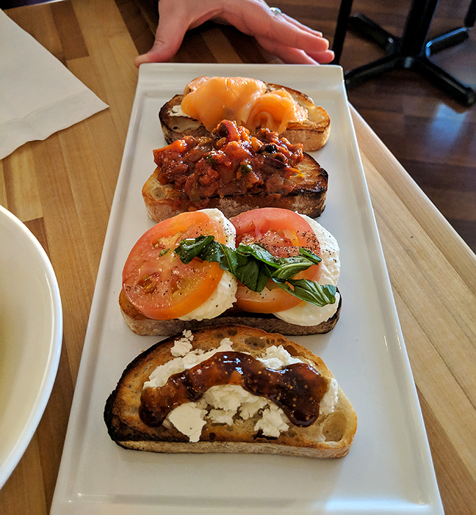 Bruschetta that deserves its own Instagram account. Four distinct varieties showcase the kitchen's creativity, with the classic tomato-basil-mozzarella stealing the spotlight. 