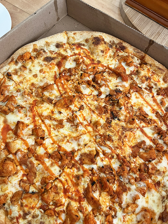 Buffalo chicken pizza nirvana&mdash;where tangy sauce meets melty cheese in a relationship so perfect it should have its own reality show.