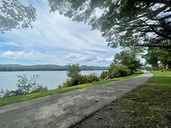 Nature's own infinity pool—Burbank Park's lakeside path invites you to wander alongside waters that mirror the Berkshire sky.