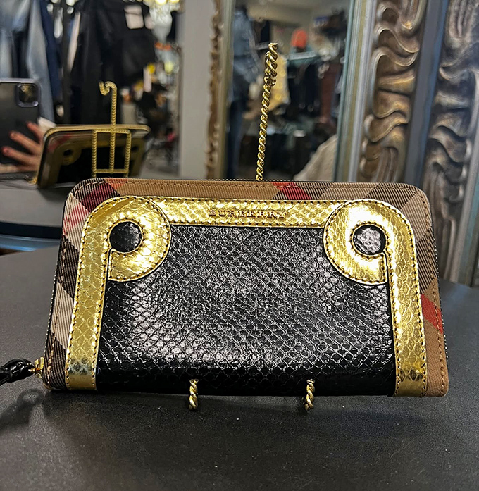 Luxury in your pocket! This designer wallet combines classic plaid with textured leather, proving good things come in small, stylishly crafted packages.