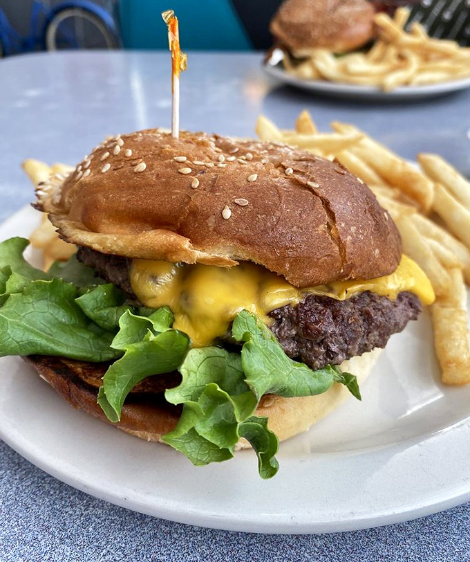 This isn't just a burger&mdash;it's edible architecture. The melty cheese cascades over a perfectly seared patty like a yellow waterfall of joy.
