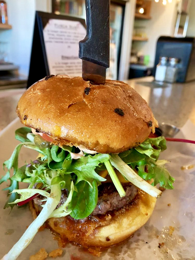 This isn't just a burger&mdash;it's an architectural marvel of flavor, where fresh greens cascade over a perfectly seared patty like a delicious waterfall.