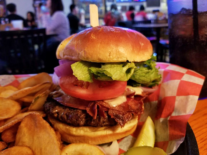 This isn't just a burger; it's a towering monument to beef perfection. Crispy bacon, fresh veggies, and a golden bun that somehow defies the laws of structural integrity.