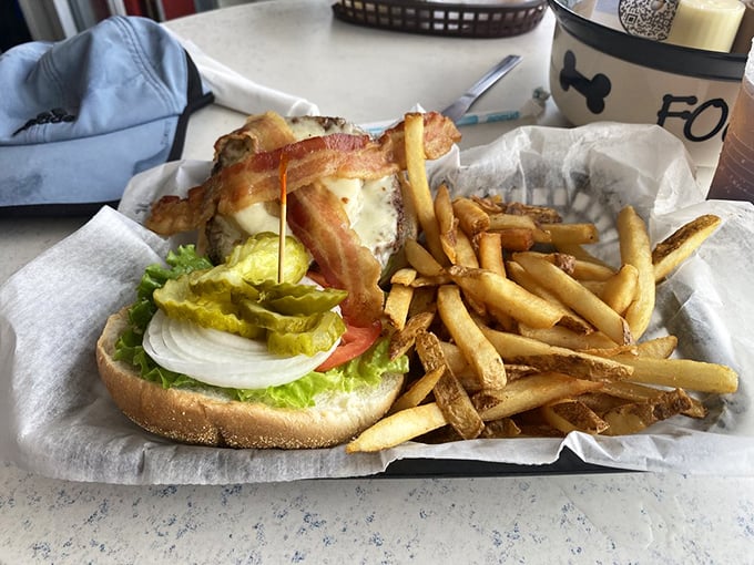 This burger doesn't just come with bacon—it's wearing it like a crown. The fries aren't sidekicks, they're co-stars.