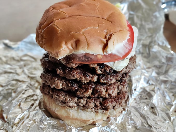 Behold the tower of power—where multiple patties create a skyscraper of flavor that requires both hands and possibly a building permit.