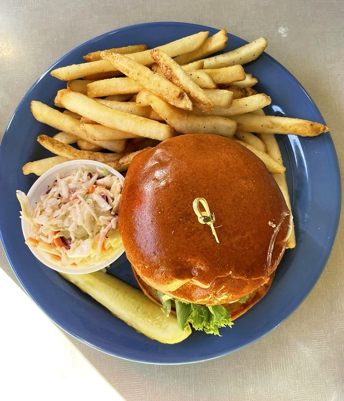 This isn't just a burger &ndash; it's a masterpiece of beef architecture on a brioche throne, with crispy fries standing guard and coleslaw providing cool contrast.