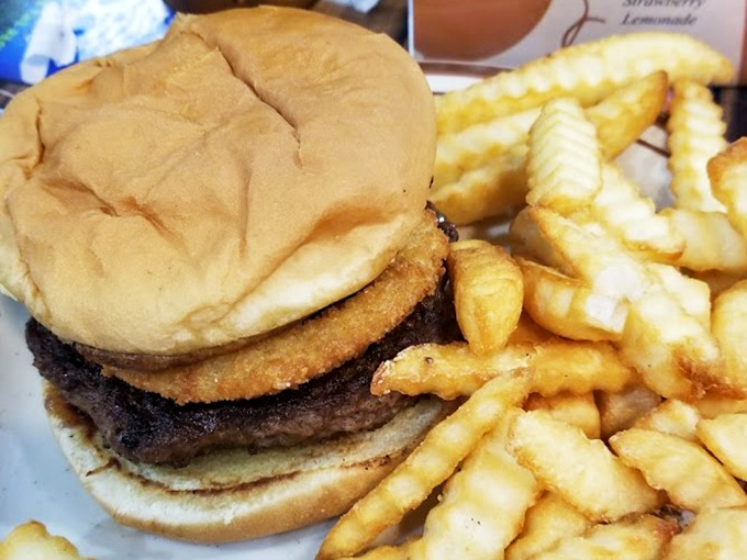 This burger sits on that plate like it owns the place, and honestly, with that perfectly grilled patty, it has every right.