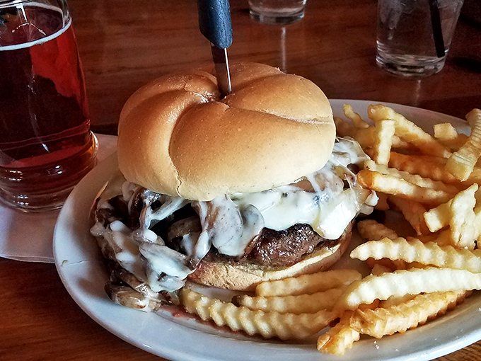That mushroom Swiss burger looks like it could solve world peace, one perfectly melted cheese pull at a time.