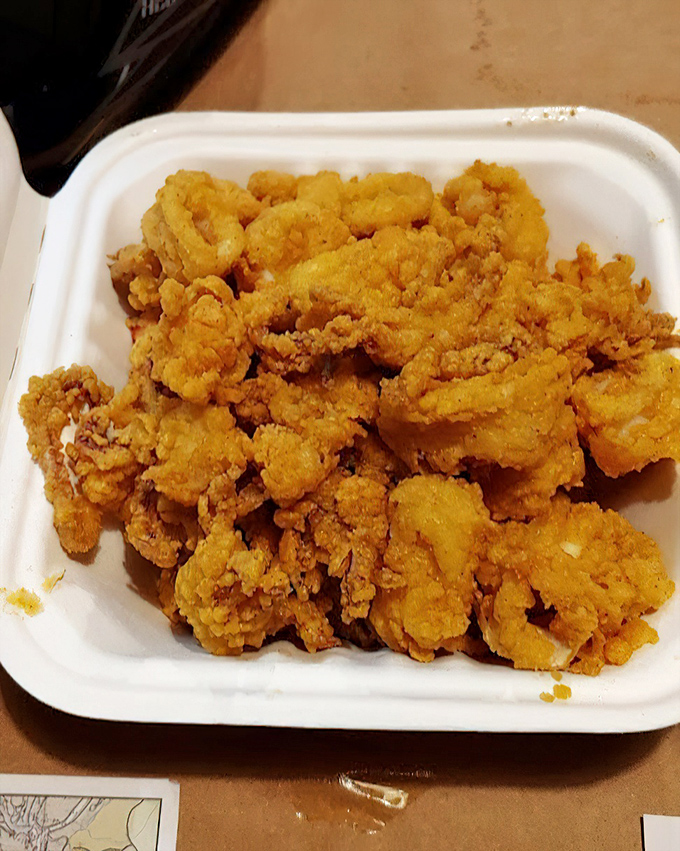 Golden treasures from the deep! These hand-breaded calamari bites are the crispy prelude to a seafood symphony.