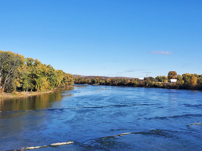 The Susquehanna River flows like liquid history past Duncannon's shores, its autumn-kissed banks a canvas of nature's finest work.