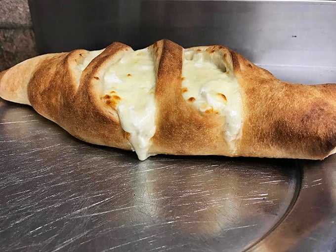 That moment when the calzone splits open and cheese makes its dramatic escape&mdash;it's like watching delicious lava flow from a carb volcano.