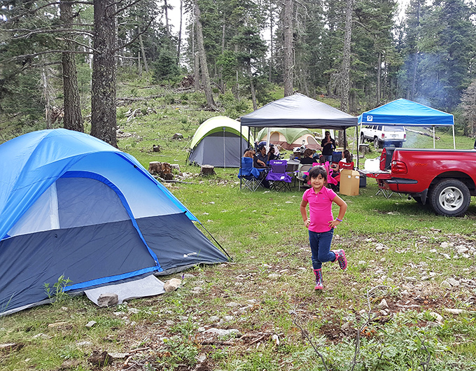 Family camping in Cloudcroft's pine-scented wilderness&mdash;where "roughing it" still includes colorful tents and the joy of children running free among towering trees.
