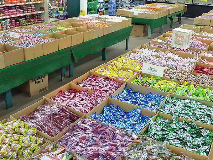 Bulk candy bins organized by color like someone's playing Connect Four with your childhood sweet tooth memories.