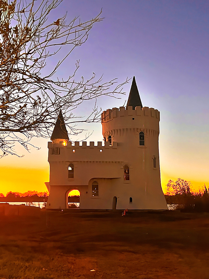 Golden hour bathes the castle in warm light, turning this quirky roadside attraction into something truly enchanting as day fades to dusk.