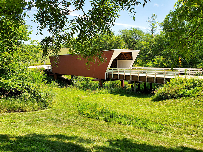 Cedar Bridge stands as a rustic sentinel over peaceful waters, its weathered wood frame housing countless whispered secrets and, yes, perhaps a forbidden rendezvous or two.