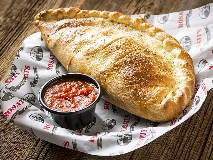 The calzone: Italy's answer to the question "What if we folded a pizza and made it portable?" This golden pocket of joy demands attention.