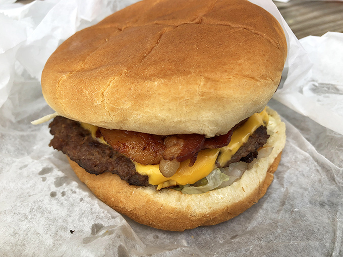 Behold the star of the show – a perfectly proportioned burger with melty cheese and bacon that would make vegetarians question their life choices.