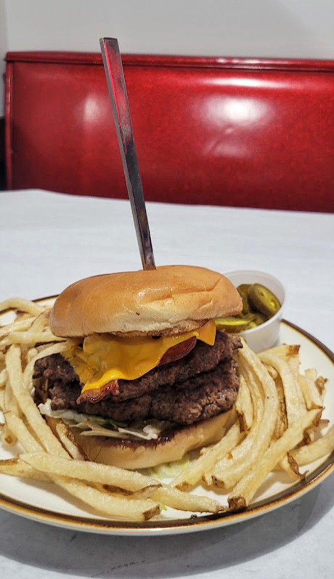 The burger that launched a thousand food dreams. That knife isn't for cutting&mdash;it's a victory flag planted on a mountain of beefy perfection.