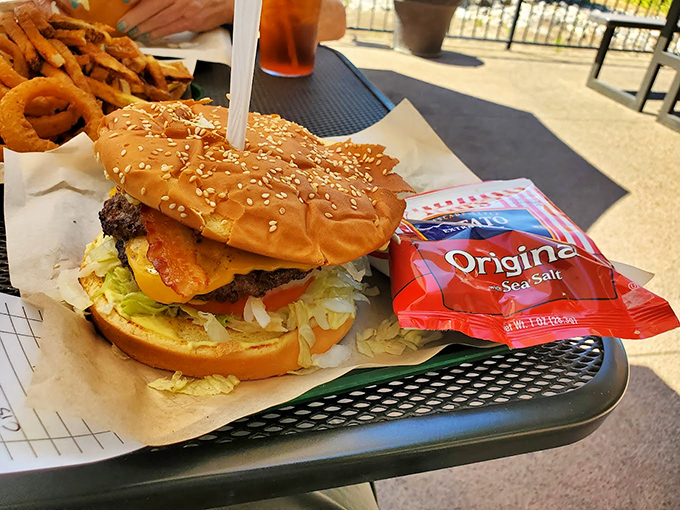 This isn't just a burger; it's an architectural marvel of beef, cheese, and fresh toppings that requires both hands and absolute commitment.