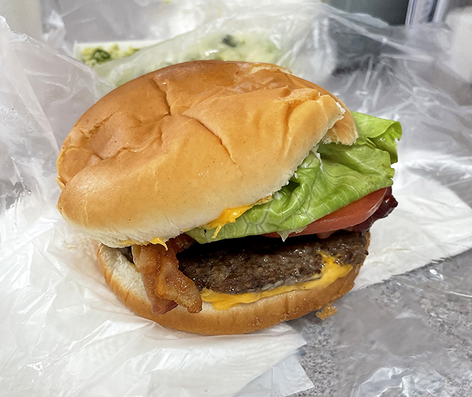 Behold the humble hero of Doumar's—a cheeseburger that doesn't need height or gimmicks to achieve greatness, just fresh beef and proper grilling technique.
