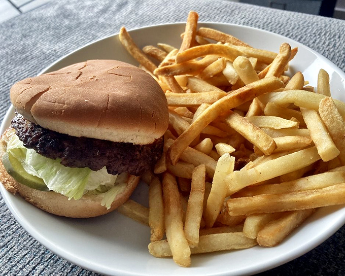 This isn't just a cheeseburger; it's edible architecture where crispy fries play supporting role to the main attraction.