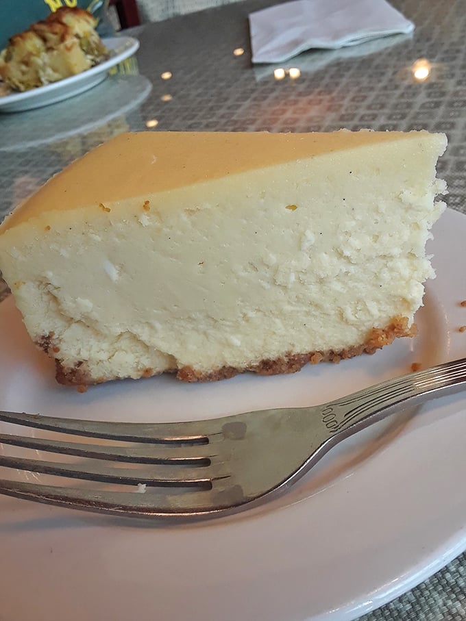 Behold the star attraction: a slice of cheesecake so perfect it deserves its own Instagram account. That graham cracker crust is the supporting actor that deserves an Oscar.