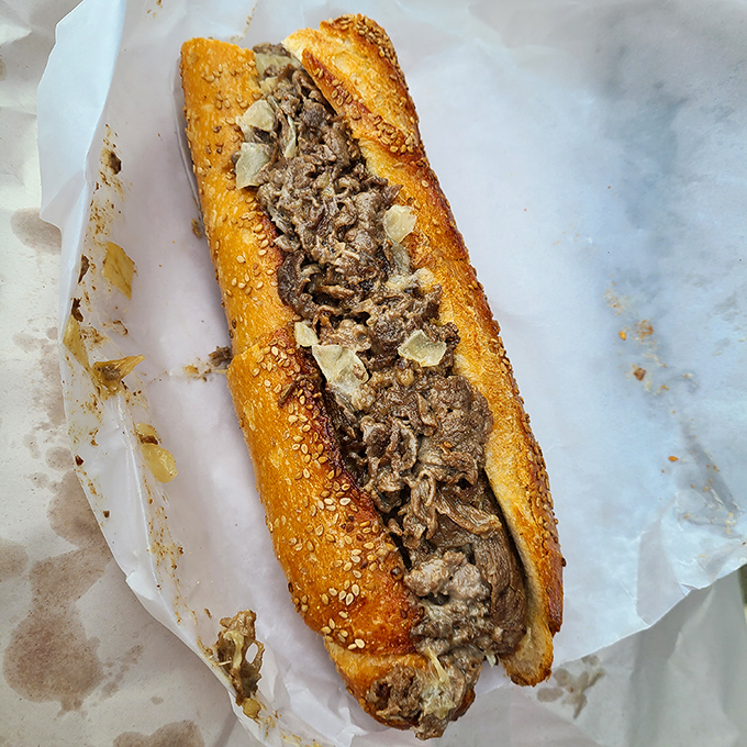 Behold the star of the show: thinly sliced beef nestled in a seeded roll that's somehow both sturdy and tender.
