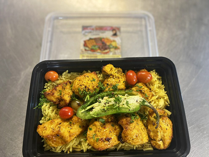 This isn't meal prep; it's edible art. Perfectly seasoned chicken kebab nestled on saffron rice with fresh vegetables makes even plastic containers look gourmet.