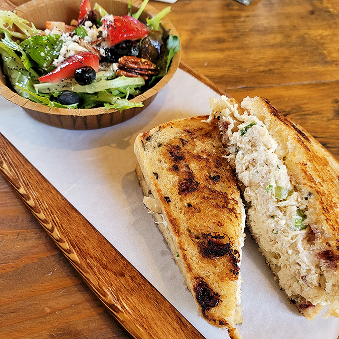 The legendary chicken salad sandwich in its natural habitat, perfectly toasted bread revealing a creamy filling that's worth crossing county lines for.
