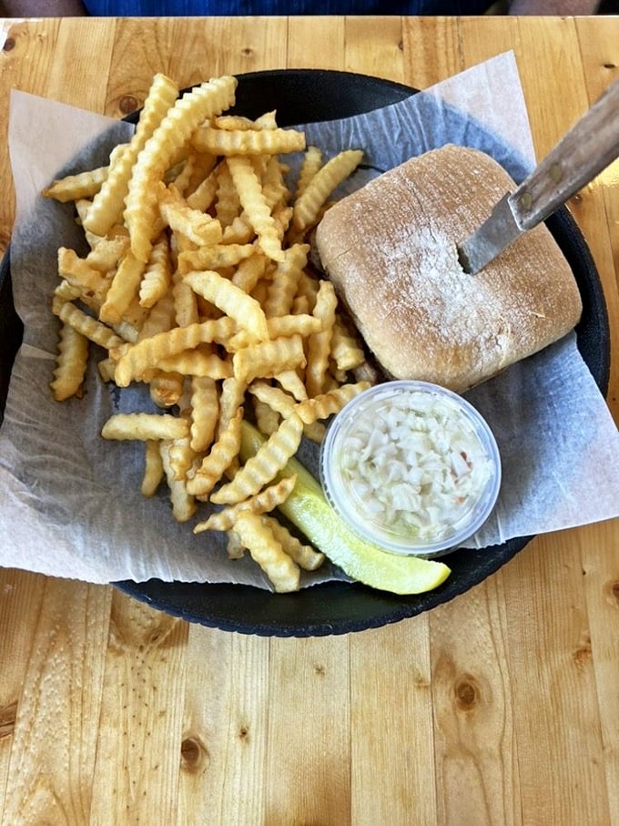 Crinkle-cut fries that crunch just right, coleslaw with the perfect balance of creamy and tangy, and a sandwich that makes fast-food chains weep with inadequacy.