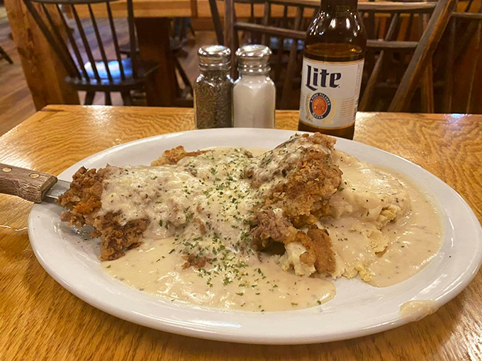 Behold! The legendary chicken fried steak in all its gravy-drenched glory. This isn't just dinner; it's what dreams are made of when cardiologists aren't looking.