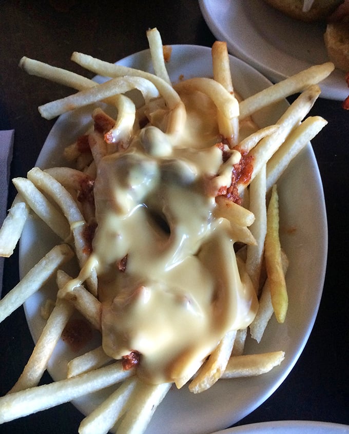 These chili cheese fries aren't just a side dish&mdash;they're the main event. Golden fries disappearing under an avalanche of chili and melted cheese. Resistance is futile.