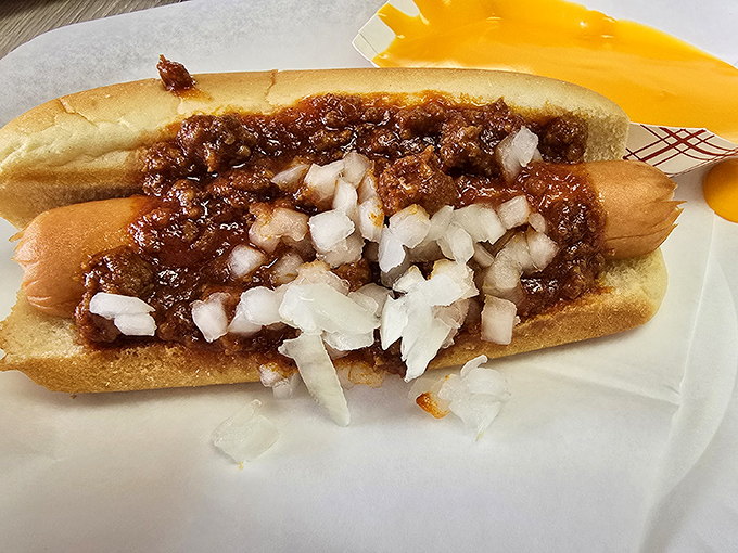 This isn't just a chili dog; it's a masterclass in balance&mdash;savory meat, tangy onions, and that homemade chili your dreams are made of.