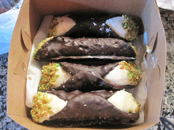 Chocolate cannoli shells filled with sweet ricotta cream – basically what angels snack on during their coffee breaks.