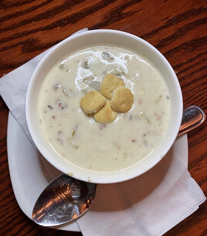 This isn't just clam chowder—it's a creamy bowl of maritime history, topped with oyster crackers that provide the perfect textural counterpoint to each velvety spoonful.