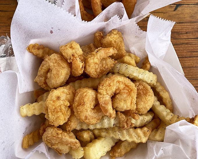 Golden treasures from the deep. These clam strips and fries aren't just food&mdash;they're edible sunshine that crackles with each heavenly bite.