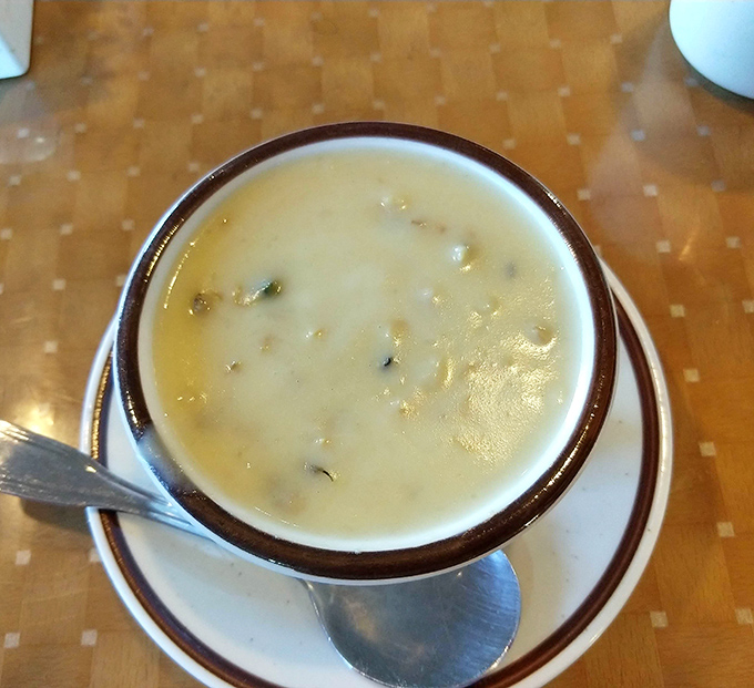 The clam chowder arrives like a creamy revelation in a simple brown-rimmed bowl &ndash; proof that seafood excellence can thrive 300 miles from the nearest ocean.