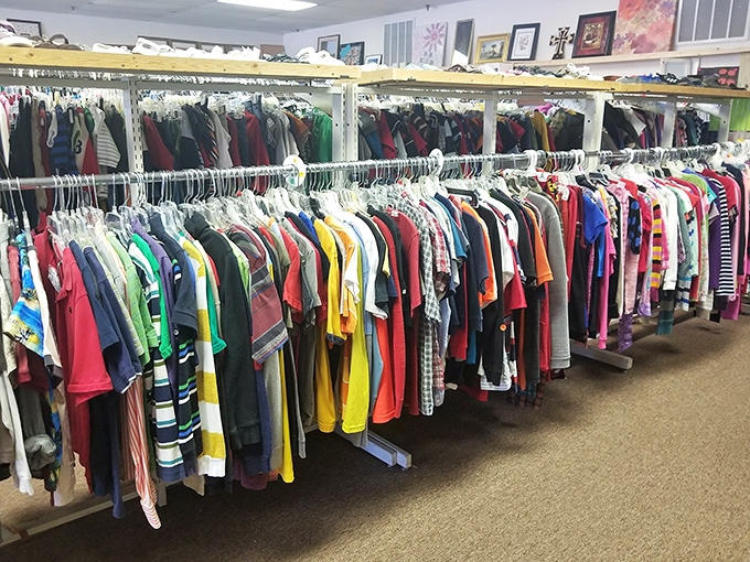 Clothing racks stretch toward the horizon like a textile sea. The thrill of the hunt keeps shoppers scanning for designer labels among everyday finds.