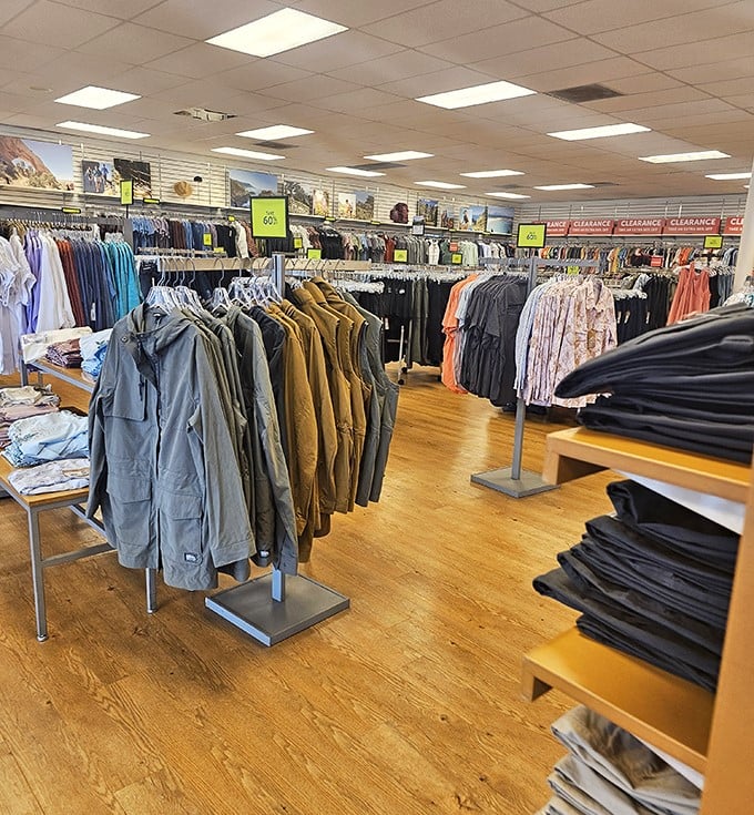 Meticulously organized racks and markdown signs tell the familiar outlet story&mdash;quality gear for less, lined up and ready for the next adventure.
