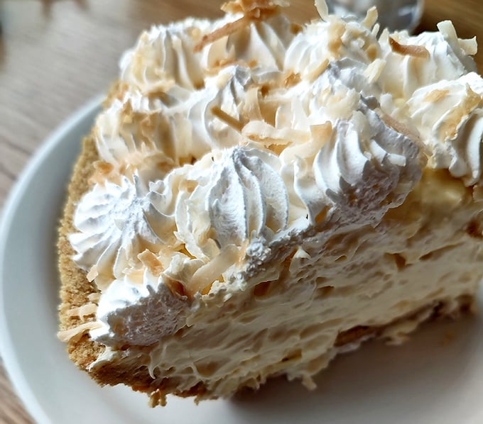 A towering slice of cream pie with pillowy whipped topping and toasted coconut&mdash;the perfect sweet finale to your Fry Bros feast.
