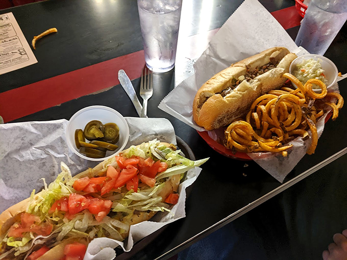 Two sandwiches walk into a diner... and become the highlight of someone's day. Those curly fries are doing a victory dance on the plate.