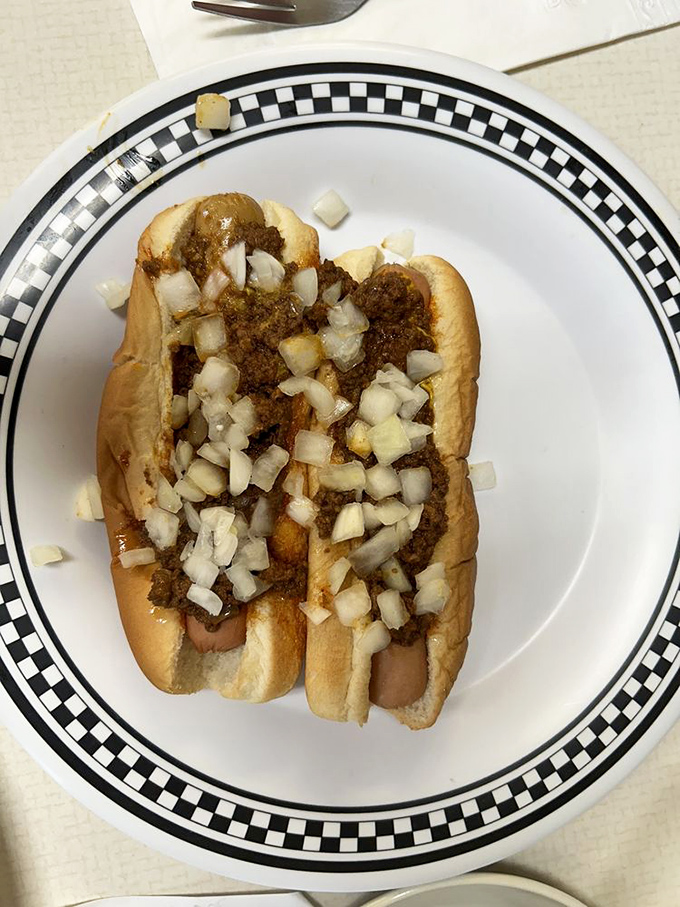 The star of the show: a perfectly steamed bun cradling a snappy coney dog, smothered in that legendary meat sauce and diced onions.