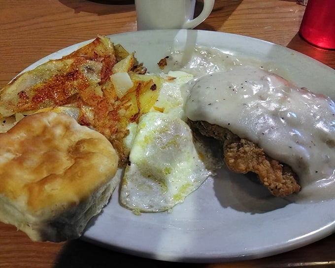 Country fried steak drowning gloriously in pepper gravy &ndash; this is what breakfast dreams are made of, folks.