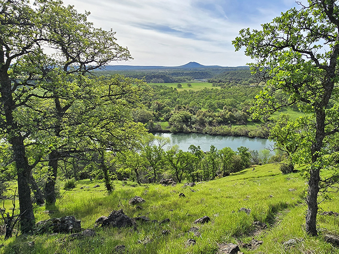 Mother Nature showing off again &ndash; rolling hills embrace a serene pond in a landscape that belongs on a calendar or your next meditation app.