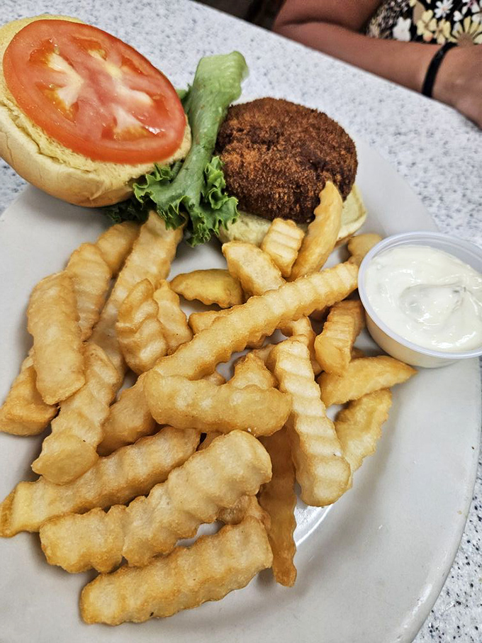 This isn't just a crab cake sandwich; it's Eastern Shore tradition on a bun, with those perfectly golden waffle fries playing a delicious supporting role.