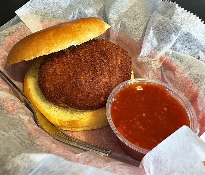 Behold the star of the show &ndash; a crab cake so packed with meat it barely needs the bun, though that soft roll makes a perfect landing pad.